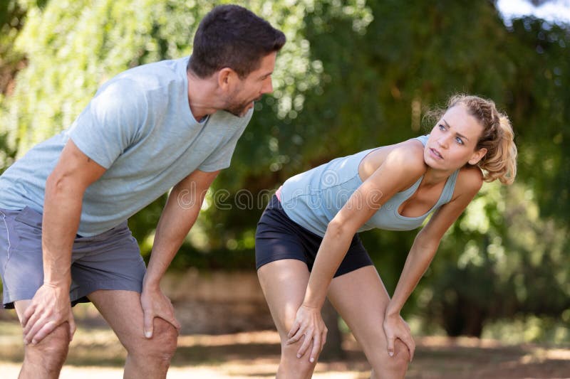 Couple Exercising Bending Over To Get Their Breath Back Stock Image ...
