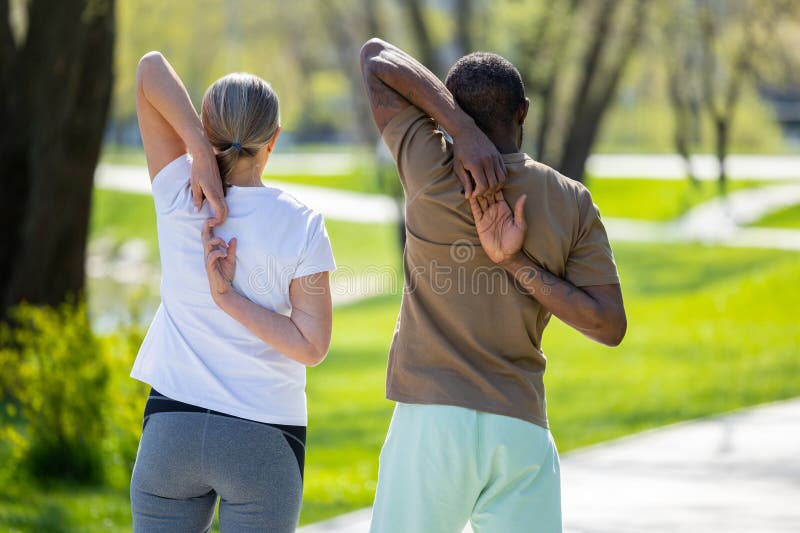 Couple Exercising in the Park and Looking Energetic Stock Photo - Image ...