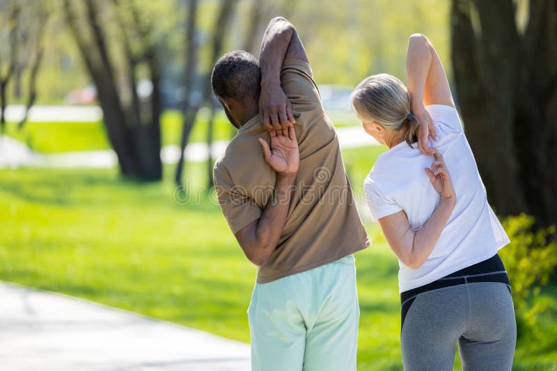 Couple Exercising in the Park and Looking Energetic Stock Photo - Image ...