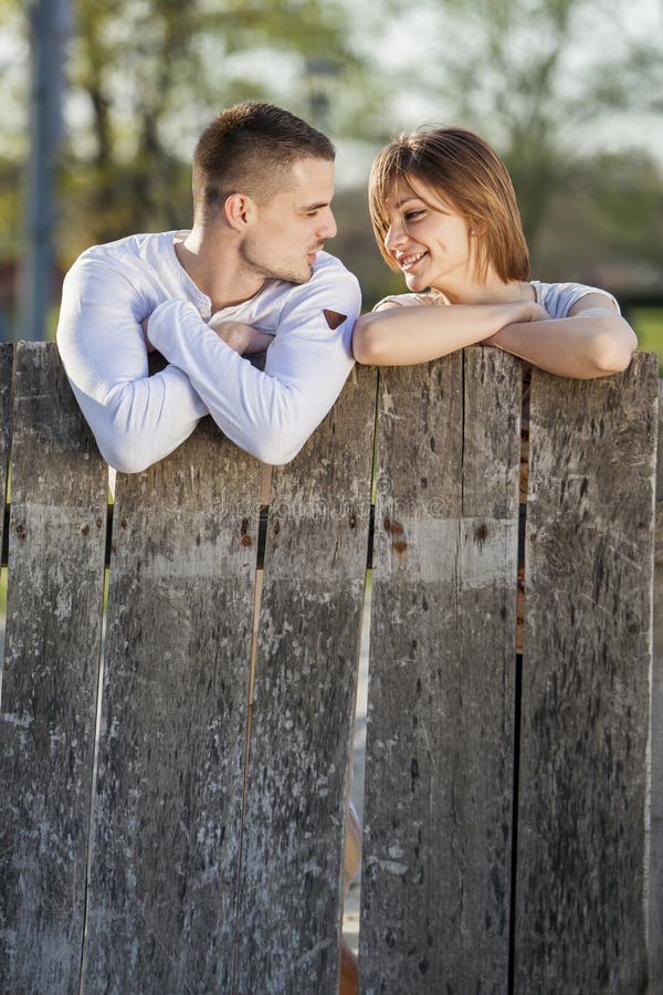 Couple by the fence stock photo. Image of women, happiness - 24625910