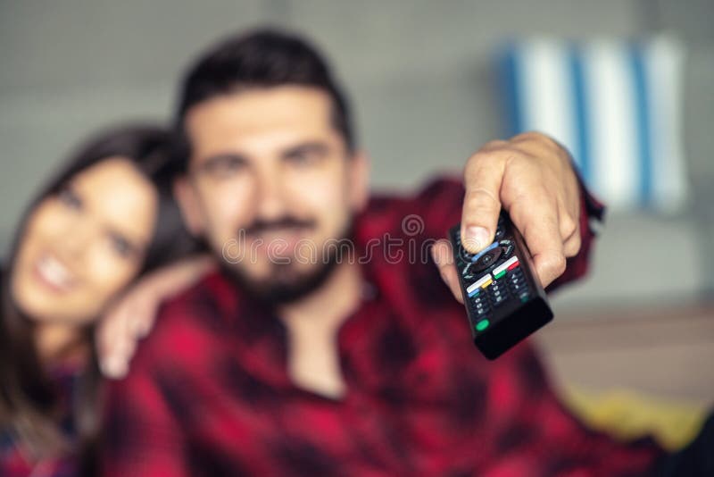Couple Fighting for Remote Control while Watching TV at Home Stock ...