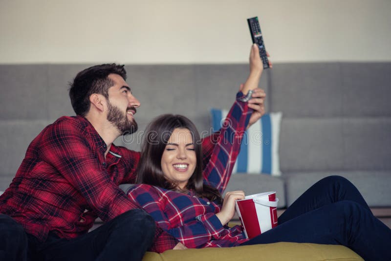 Couple Fighting for Remote Control while Watching TV at Home Stock ...