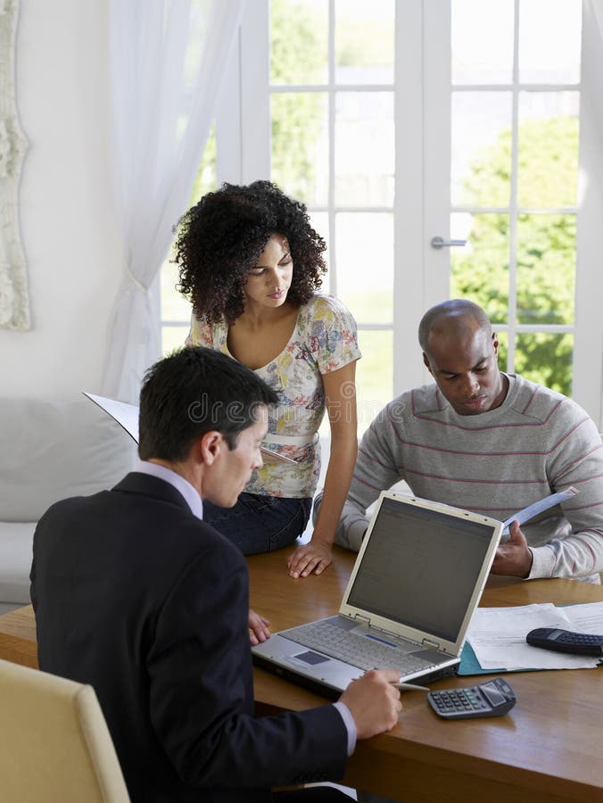 Couple with Financial Advisor at Table Stock Photo - Image of document ...
