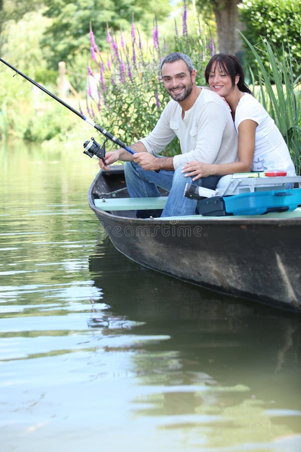 Couple Fishing or Angling Standing on River Shore in Grass Stock Photo ...