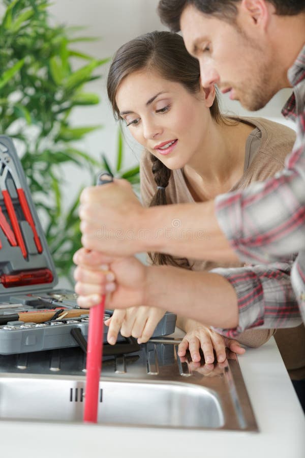 Couple fixing kitchen sink stock photo. Image of changing - 283608060