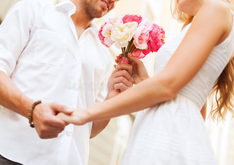 Romantic Young Couple In Love Man Holding Surprise Rose For Beautiful