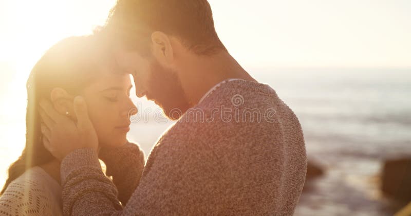 Couple Forehead Kiss And Hug On Beach Together For Romantic Sunset