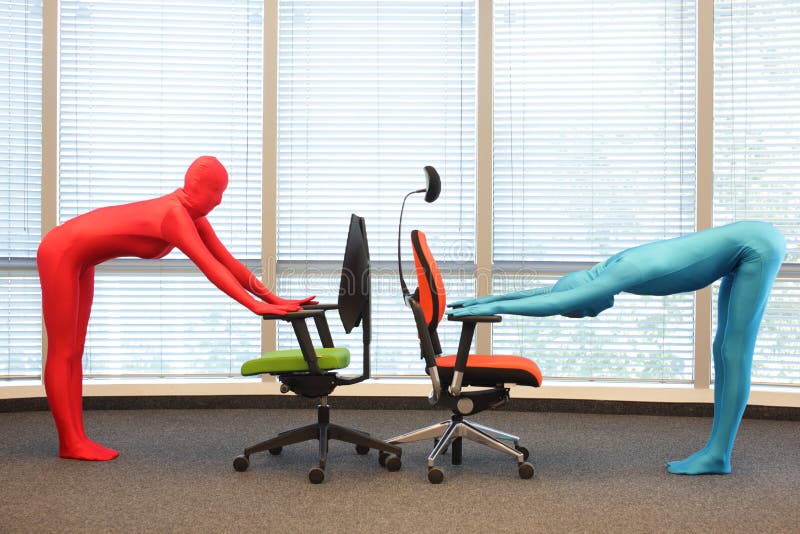 Couple in Full Body Elastic Suits Exercising with Chairs in Office ...