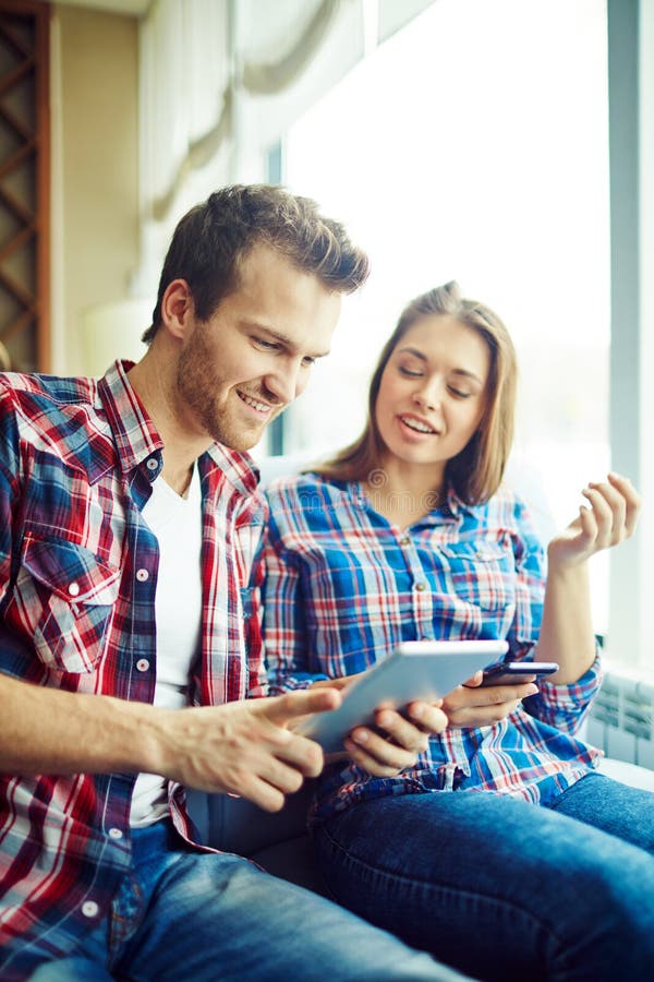 Couple with gadgets stock image. Image of talking, smiling - 69935483