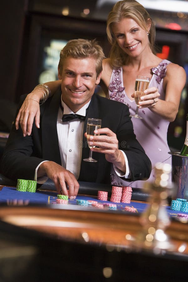 Couple Gambling at Roulette Table Stock Photo - Image of camera, casino ...