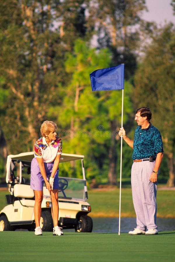 Couple Golfing 1 stock image. Image of golf, woman, talking - 306157