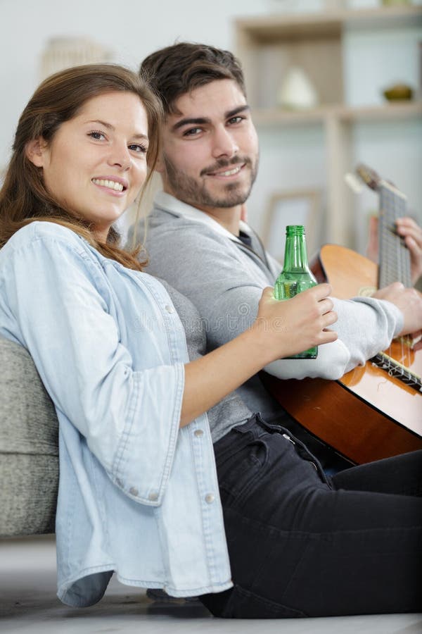 Couple with Guitar at Home Drinking Beer Stock Image - Image of plays ...