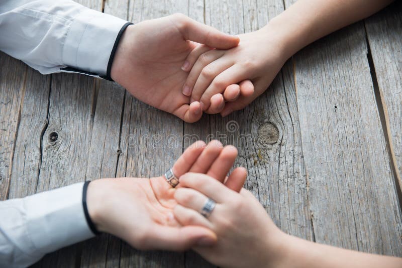 Couple Hand in Hand on Wooden Table Stock Photo - Image of human, male ...