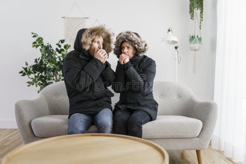 Couple Have Cold on the Sofa at Home with Winter Coat Stock Image ...
