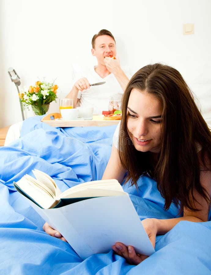 Couple Having Breakfast in Bed Stock Photo - Image of book, drinking ...