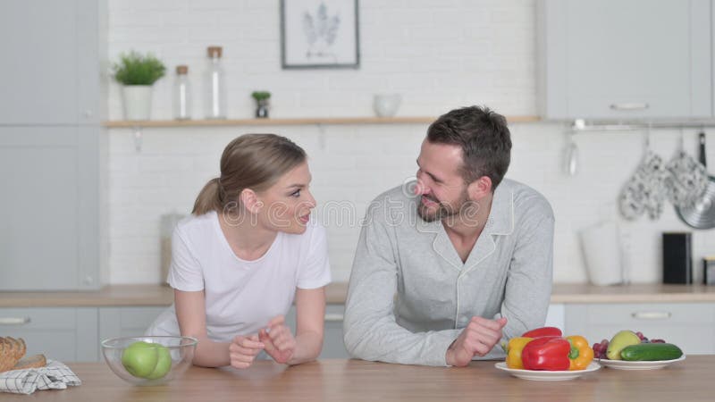 Couple Having Conversation while in Kitchen Stock Image - Image of ...