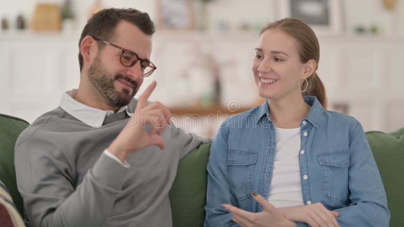 Couple Having Conversation while Sitting on Sofa Stock Image - Image of ...