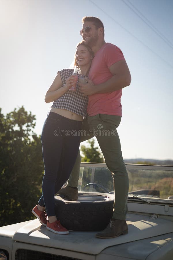 Couple Having Drinks on the Bonnet of Car Stock Image - Image of ...