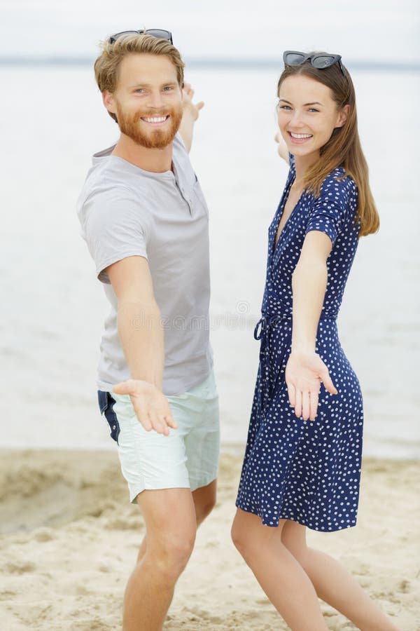 Couple having fun at beach stock photo. Image of attractive - 186439656