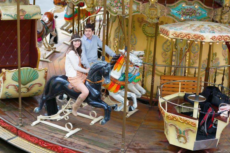 Couple Having Fun on a Merry-go-round Stock Photo - Image of family ...