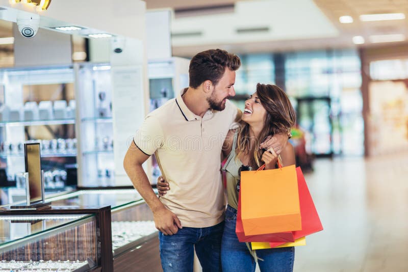 Couple Having Fun in Shopping Mall while Doing Shopping Together Stock ...