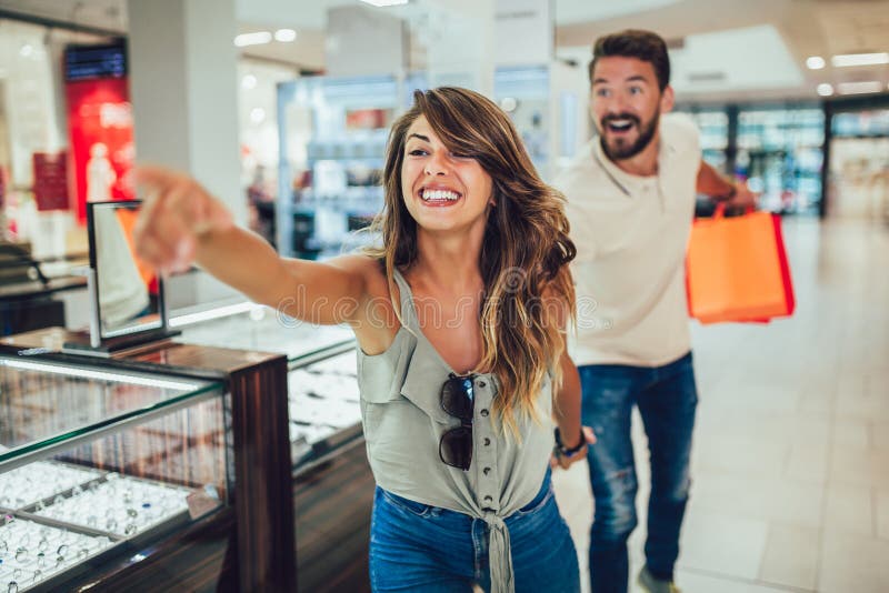 Couple Having Fun in Shopping Mall while Doing Shopping Together Stock ...