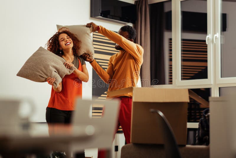 Couple Having Much Fun while Having Pillow Battle in the Evening Stock ...