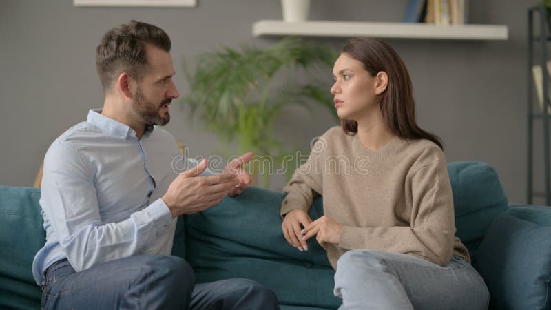Couple Having Serious Conversation while Sitting on Sofa Stock Photo ...