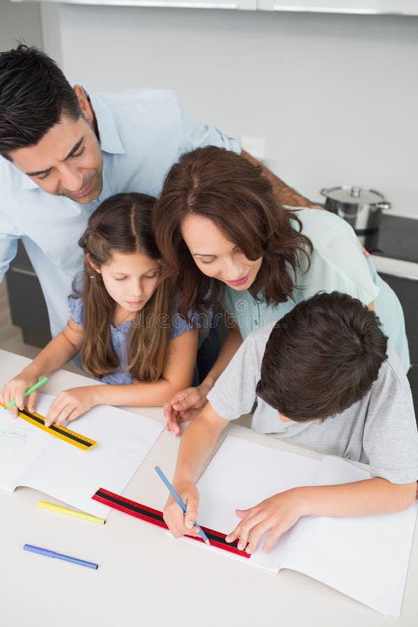 Couple Helping Kids with Their Homework Stock Photo - Image of view ...