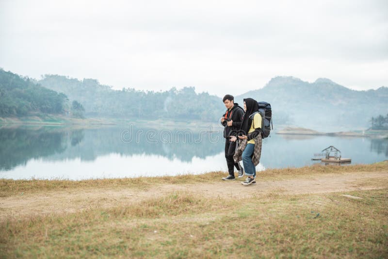 Couple Hikers with Backpacks Walking Side the Lake Stock Photo - Image ...