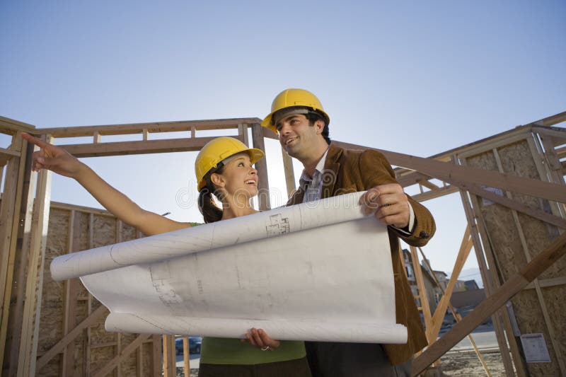 Man Holding Blueprint in Construction Site Stock Photo - Image of ...