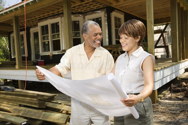 Couple Holding Building Plans Stock Photo - Image of away, building ...