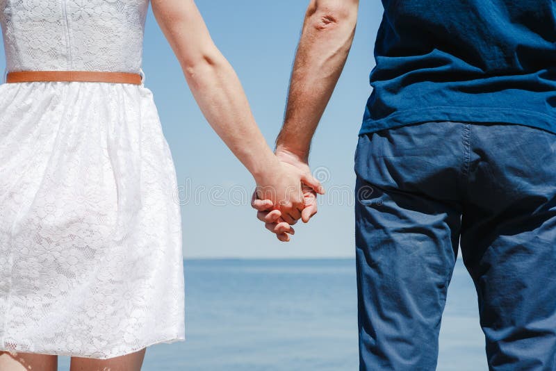 Couple Holding Hand in Hand on the Beach Stock Image - Image of concept ...