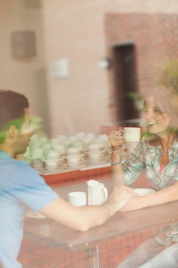 A Couple Holding Hands and Drinking Coffee Stock Image - Image of enjoy ...