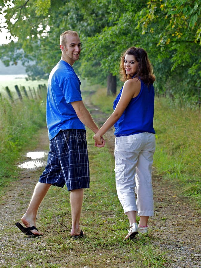 Couple Holding Hands Looking Back Stock Image - Image of walking, love ...