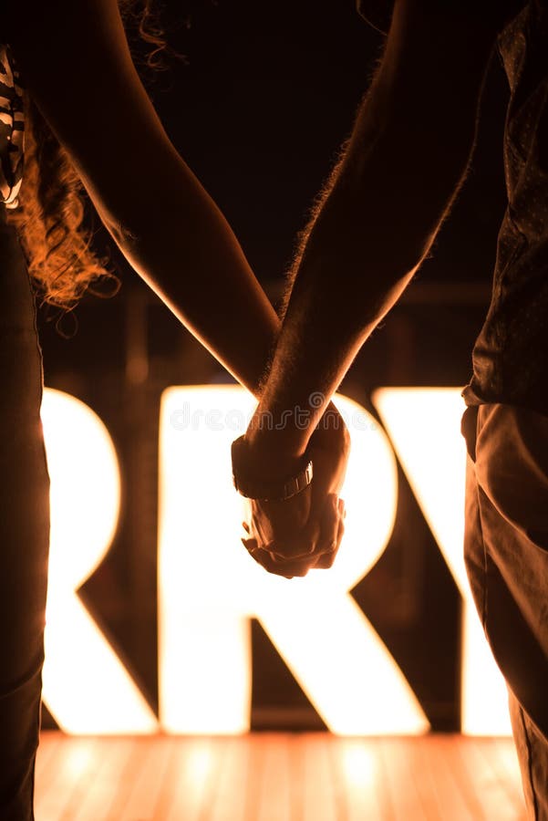 Couple Holding Hands Near Proposal Decoration Stock Photo - Image of ...