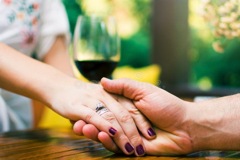 Couple Holding Hands on a Date Stock Image - Image of restaurant ...