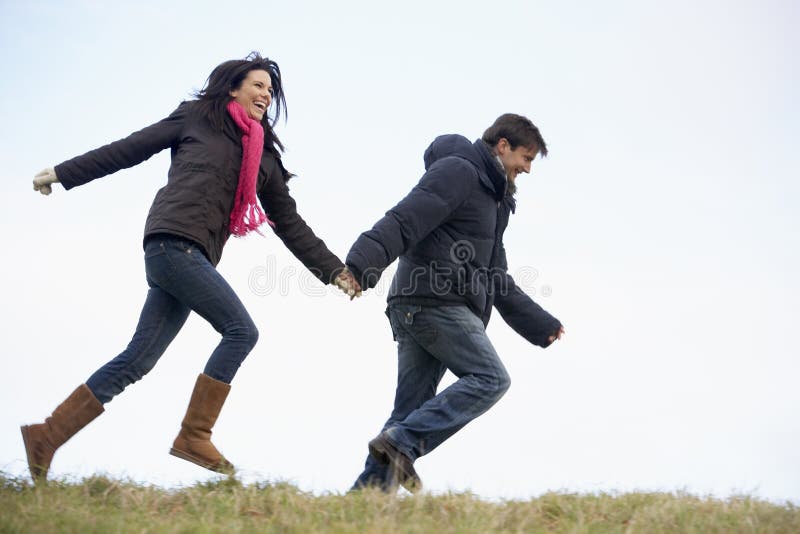 Couple Holding Hands and Running in the Park Stock Photo - Image of ...