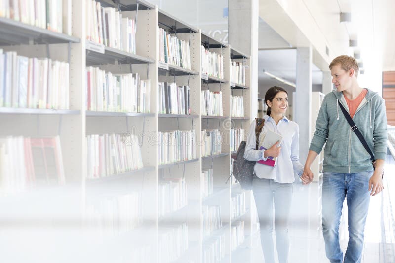 Man Walking In Library stock image. Image of holding - 29656573