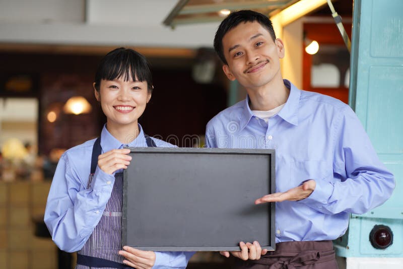 A Couple Holding a Message Board in Front of a Kitchen Car Stock Photo ...