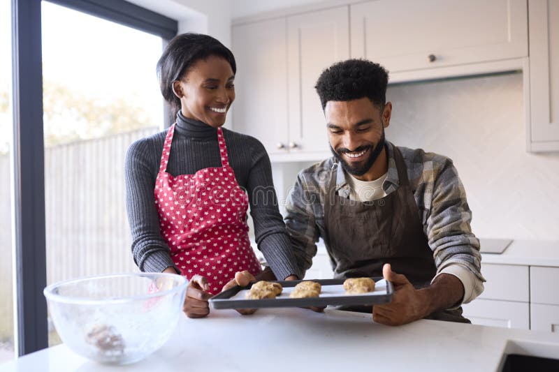 Couple at Home Baking Cookies Together in Kitchen Stock Photo - Image ...