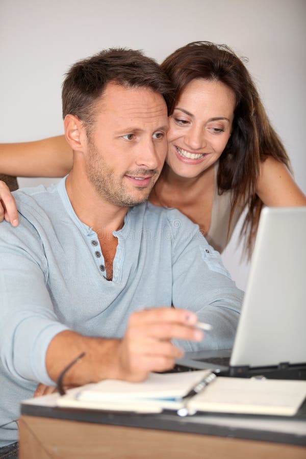 Young Couple on Laptop Computer Stock Photo - Image of indoors ...