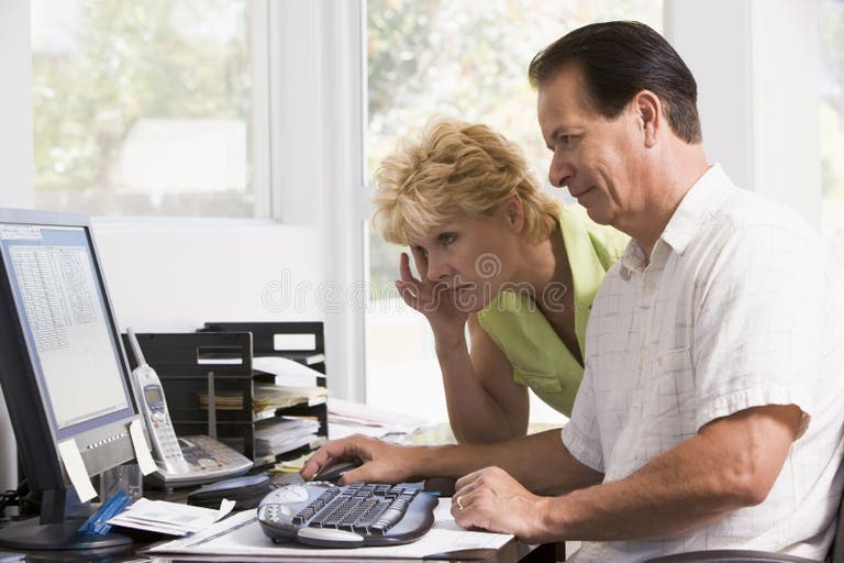 Couple in Home Office at Computer Frowning Stock Image - Image of ...