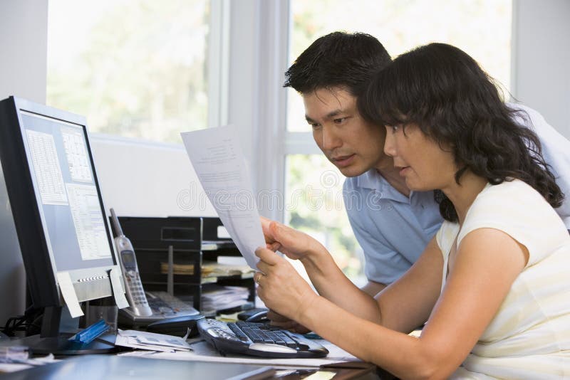 Couple in Home Office with Computer and Paperwork Stock Image - Image ...