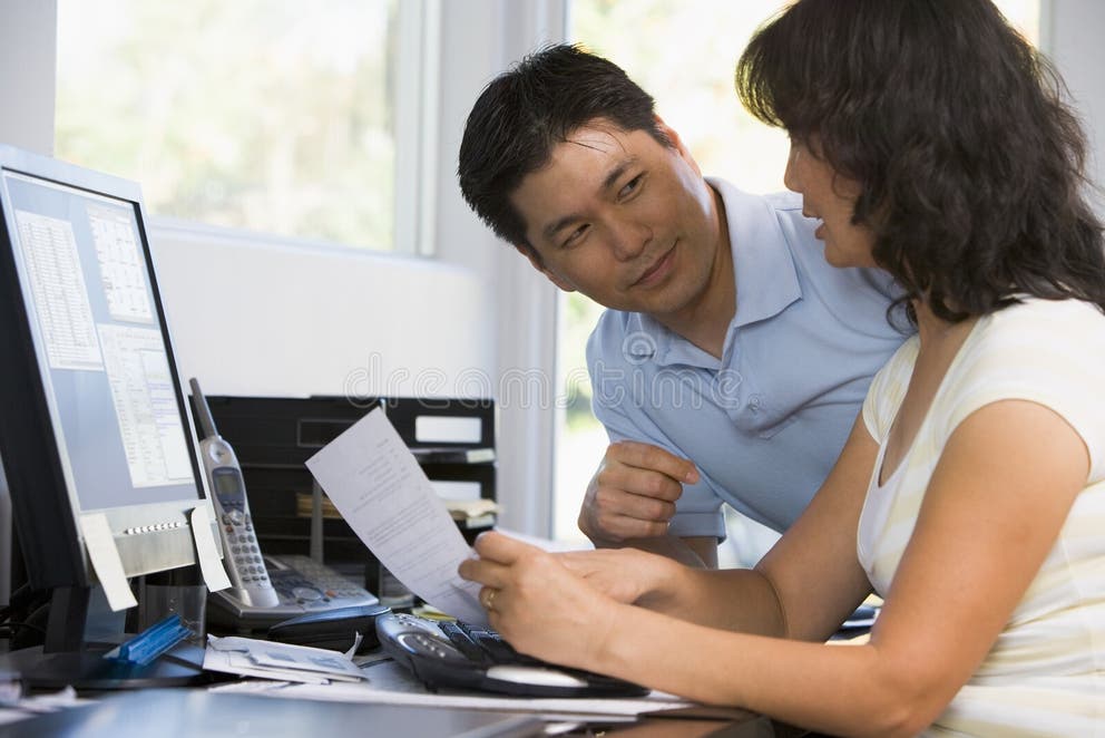 Couple in Home Office with Computer and Paperwork Stock Photo - Image ...