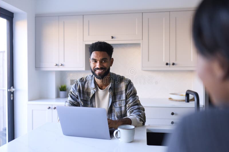 Couple at Home Working on Laptop on Counter in Kitchen Stock Image ...