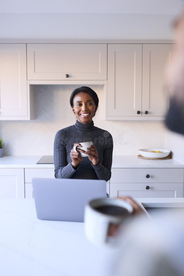 Couple at Home Working on Laptop on Counter in Kitchen Stock Image ...