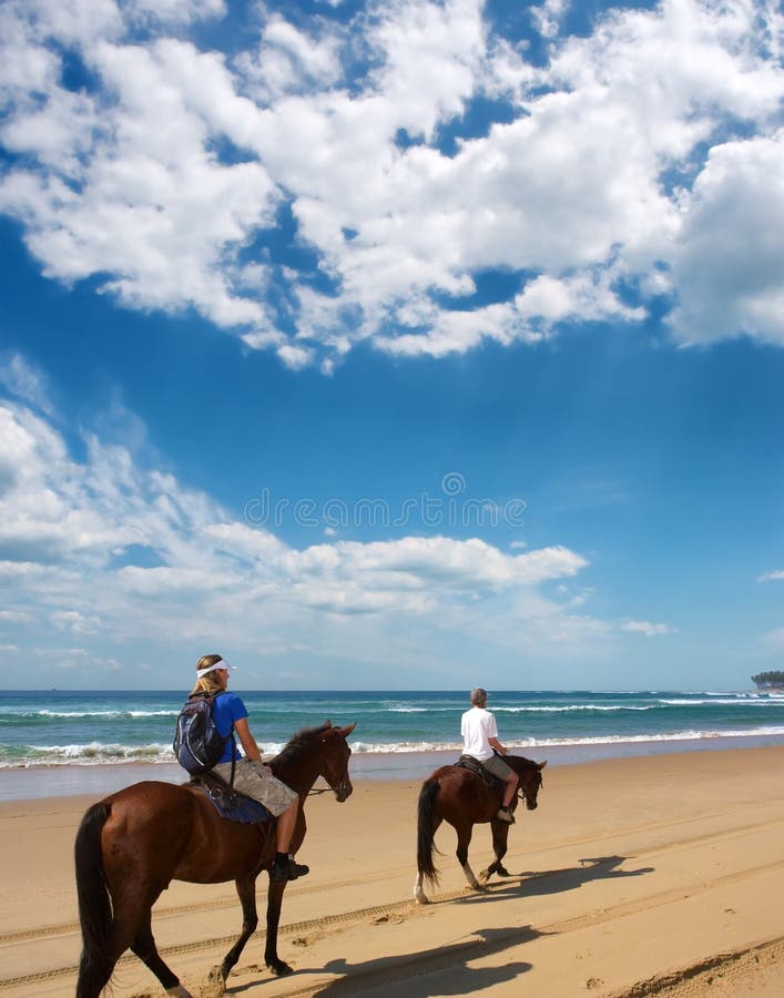 Couple of Riders on Beach Under Dramatic Skies Stock Photo - Image of ...