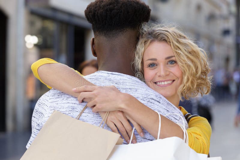 Couple Hugging on City Street Stock Photo - Image of shop, premiumvalue ...