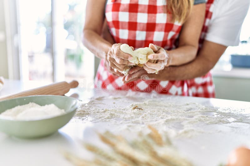 Couple Hugging and Cooking Bread at the Kitchen Stock Photo - Image of ...